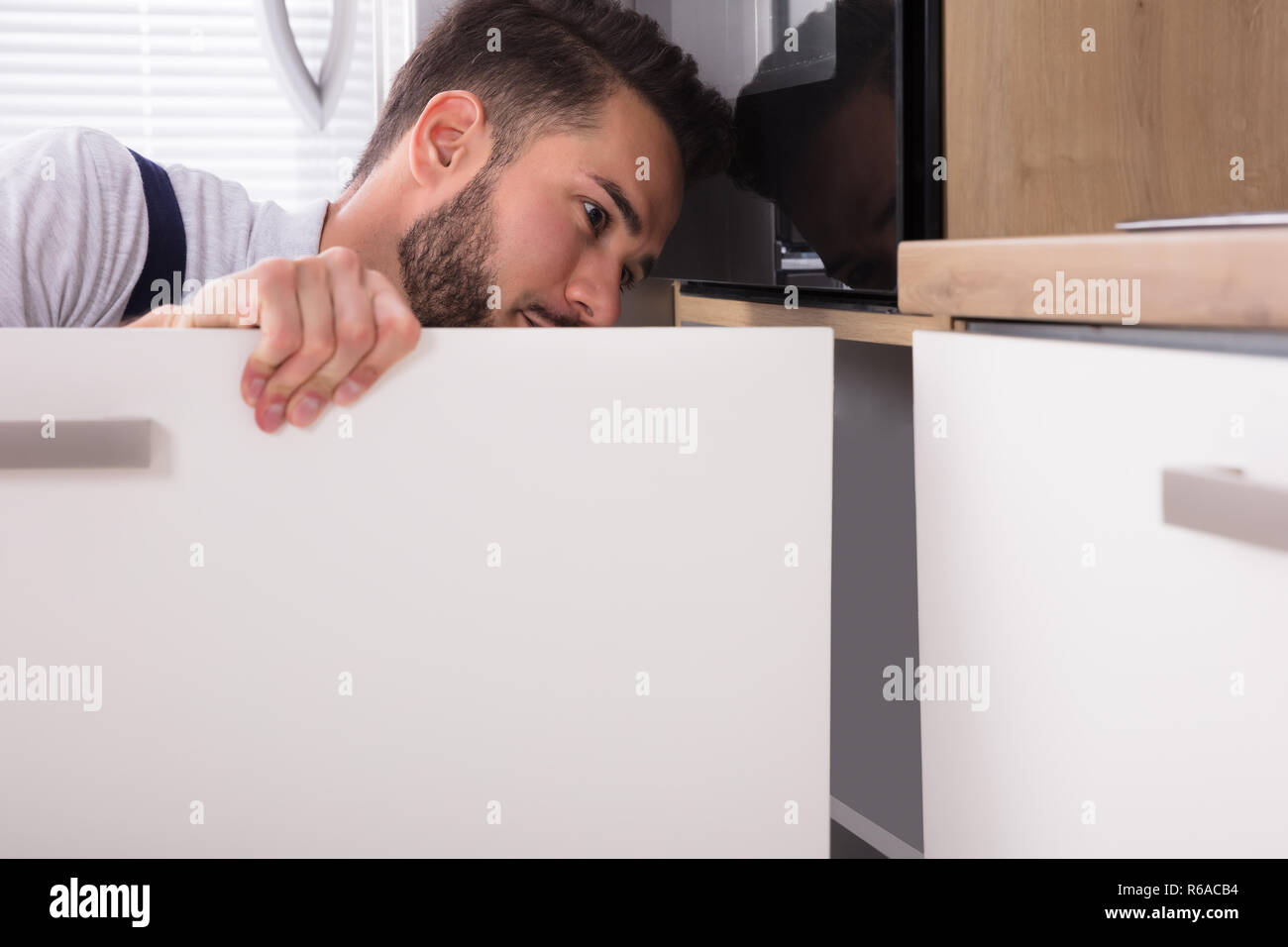 Handyman Fixing Sink Door Stock Photo - Alamy