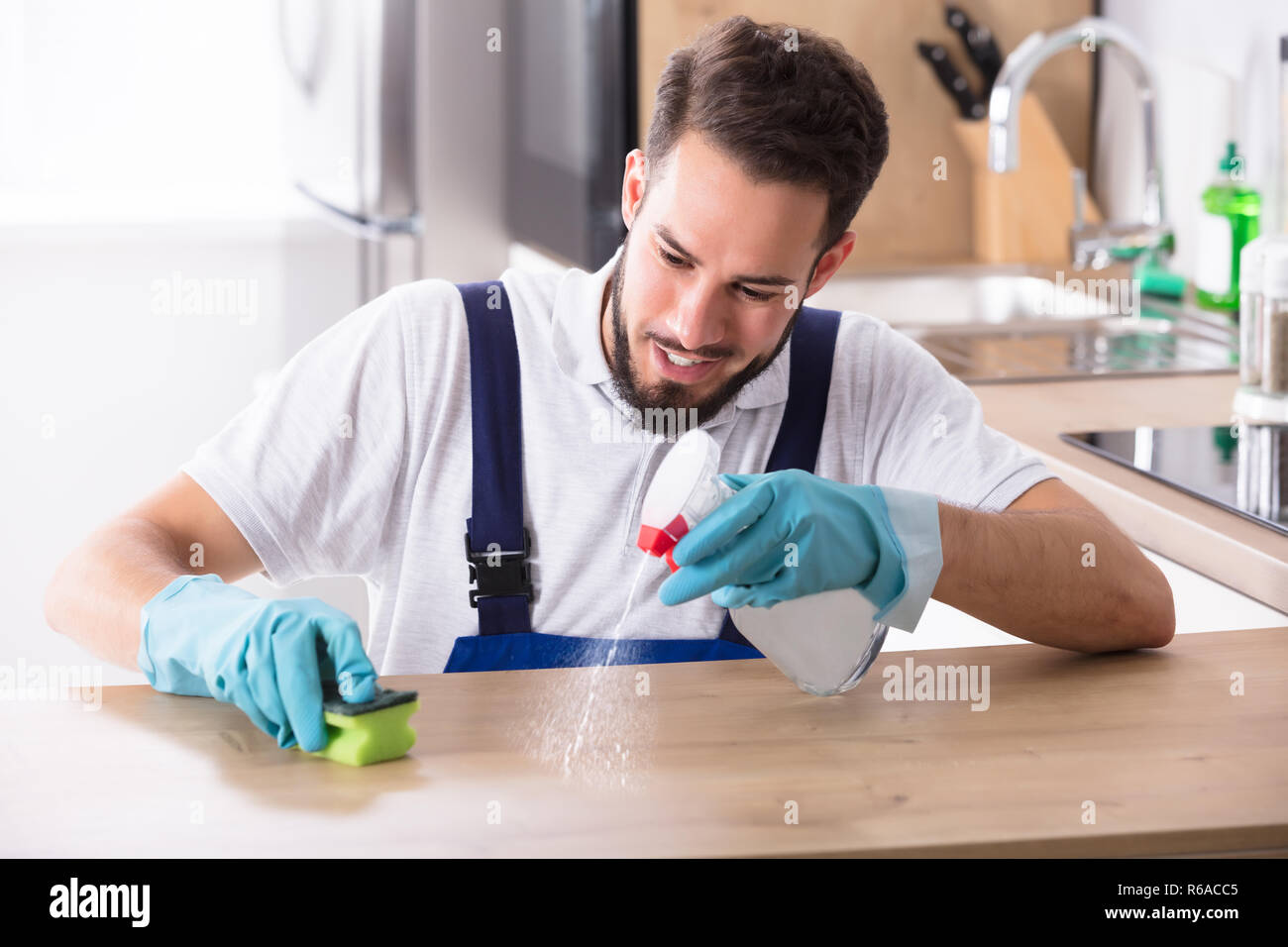 Man Cleaning Kitchen Worktop Stock Photo - Alamy