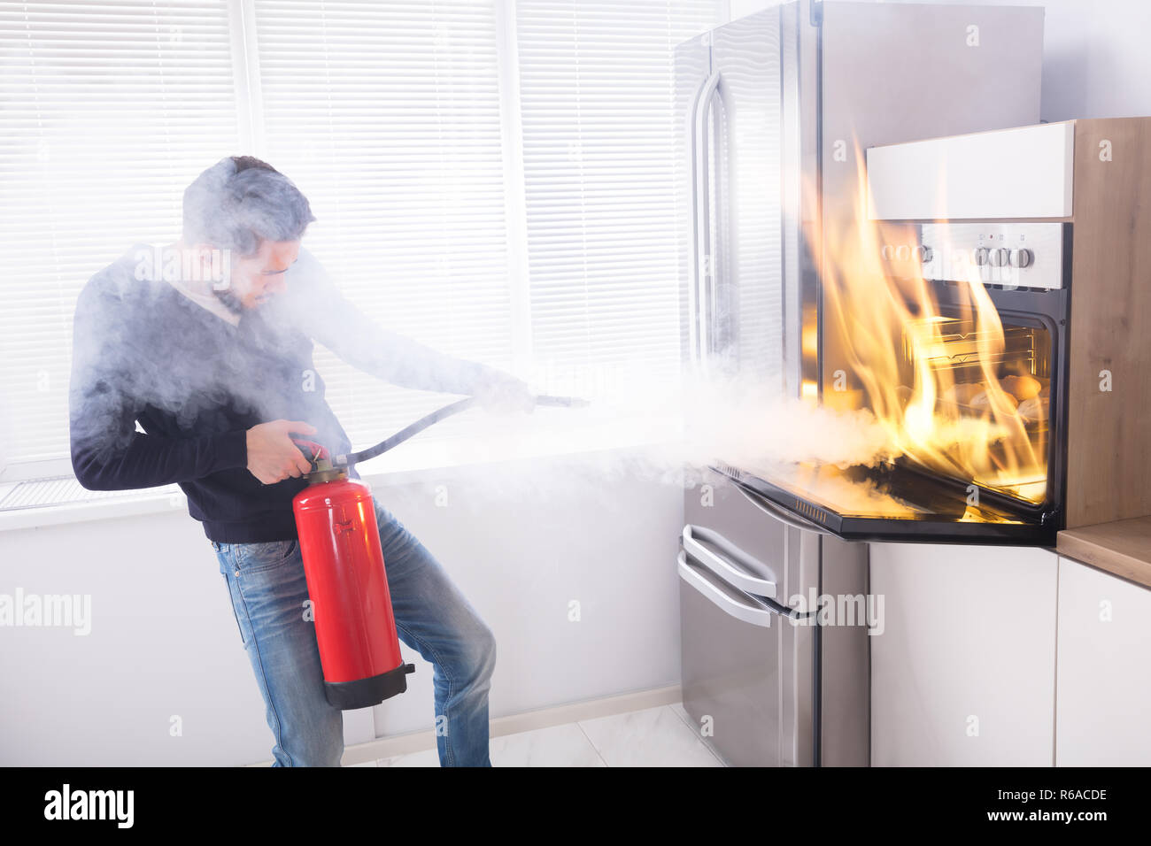 Man with fire extinguisher hi-res stock photography and images - Alamy