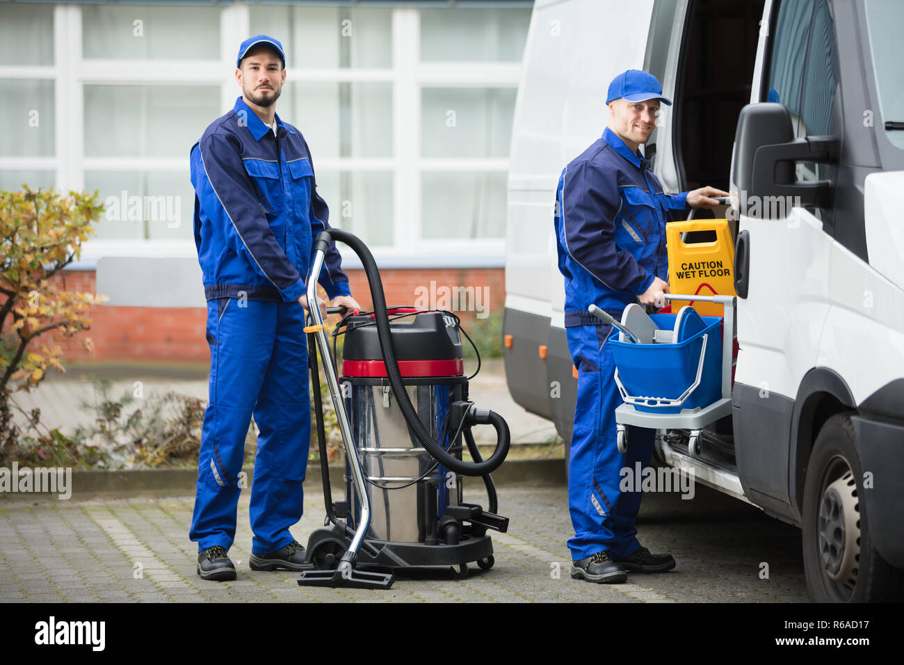 Two Male Janitor Unloading Cleaning Equipment From Vehicle Stock Photo ...