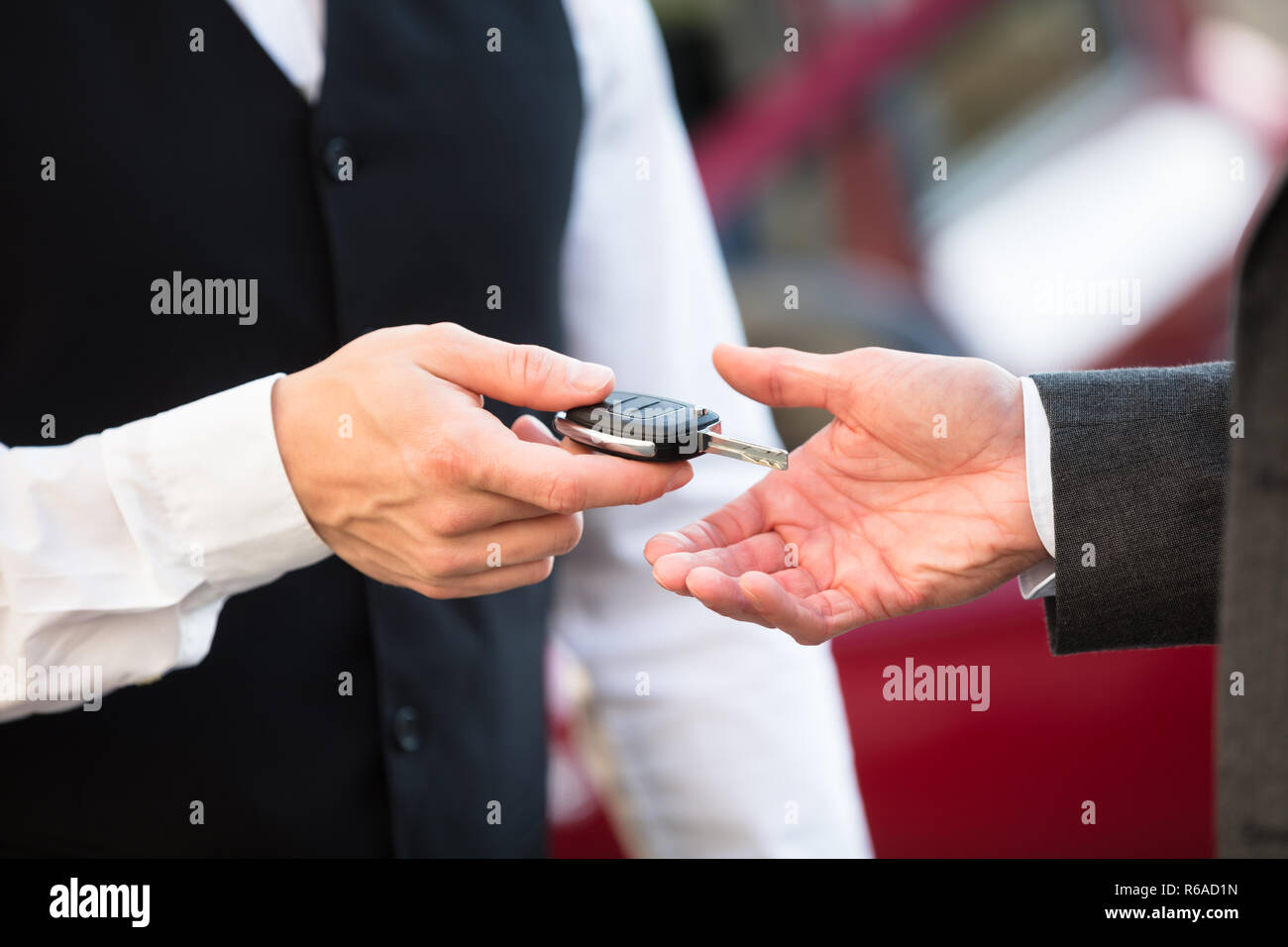 Valet Giving Car Key To Businessperson Stock Photo - Alamy