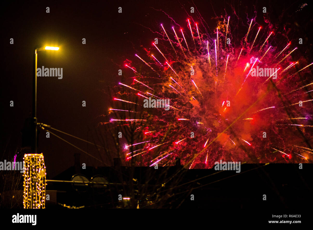 Colorful, beautiful fireworks on the night sky over the city. New Year ...