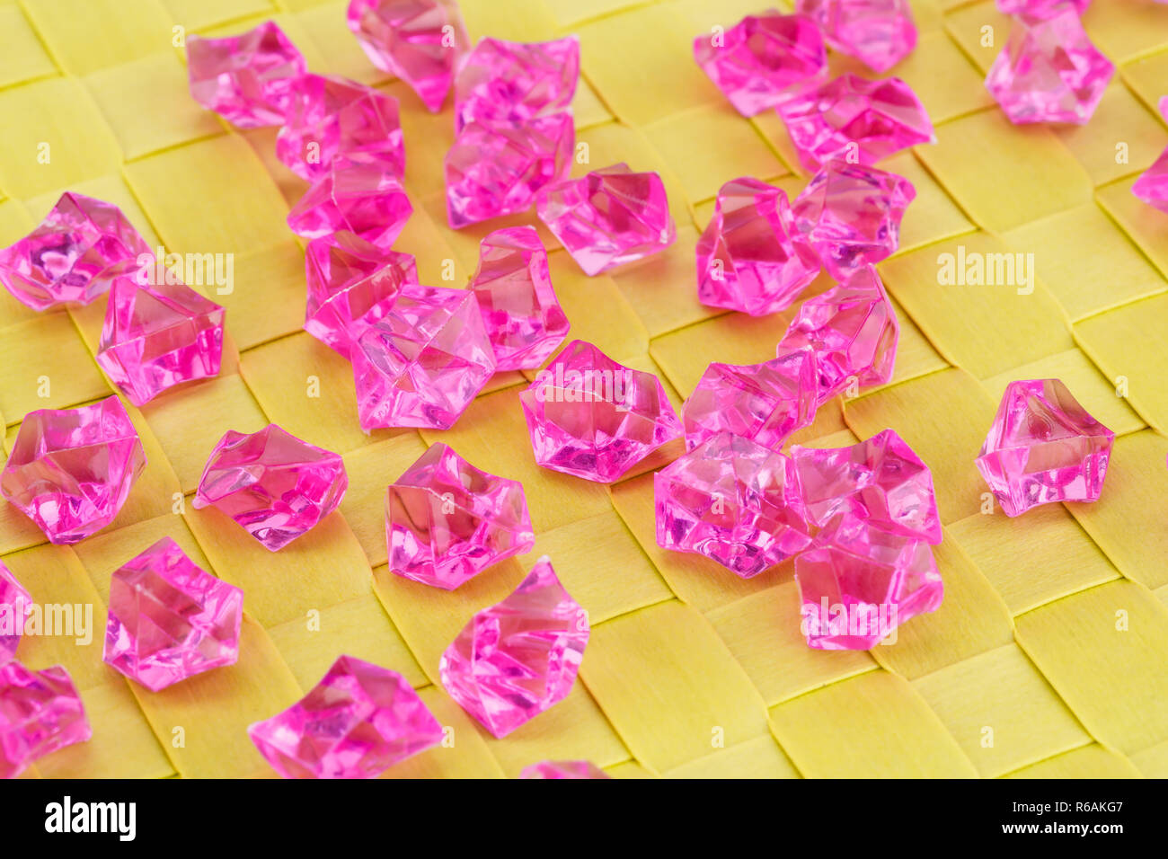 Pink plastic stones on bamboo background Stock Photo - Alamy