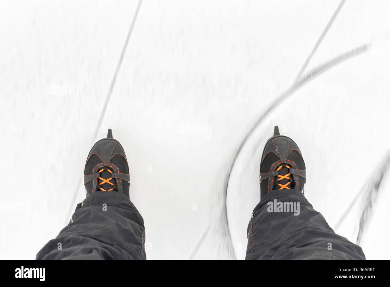feet of man rolling on ice skates on ice of frozen river Stock Photo ...