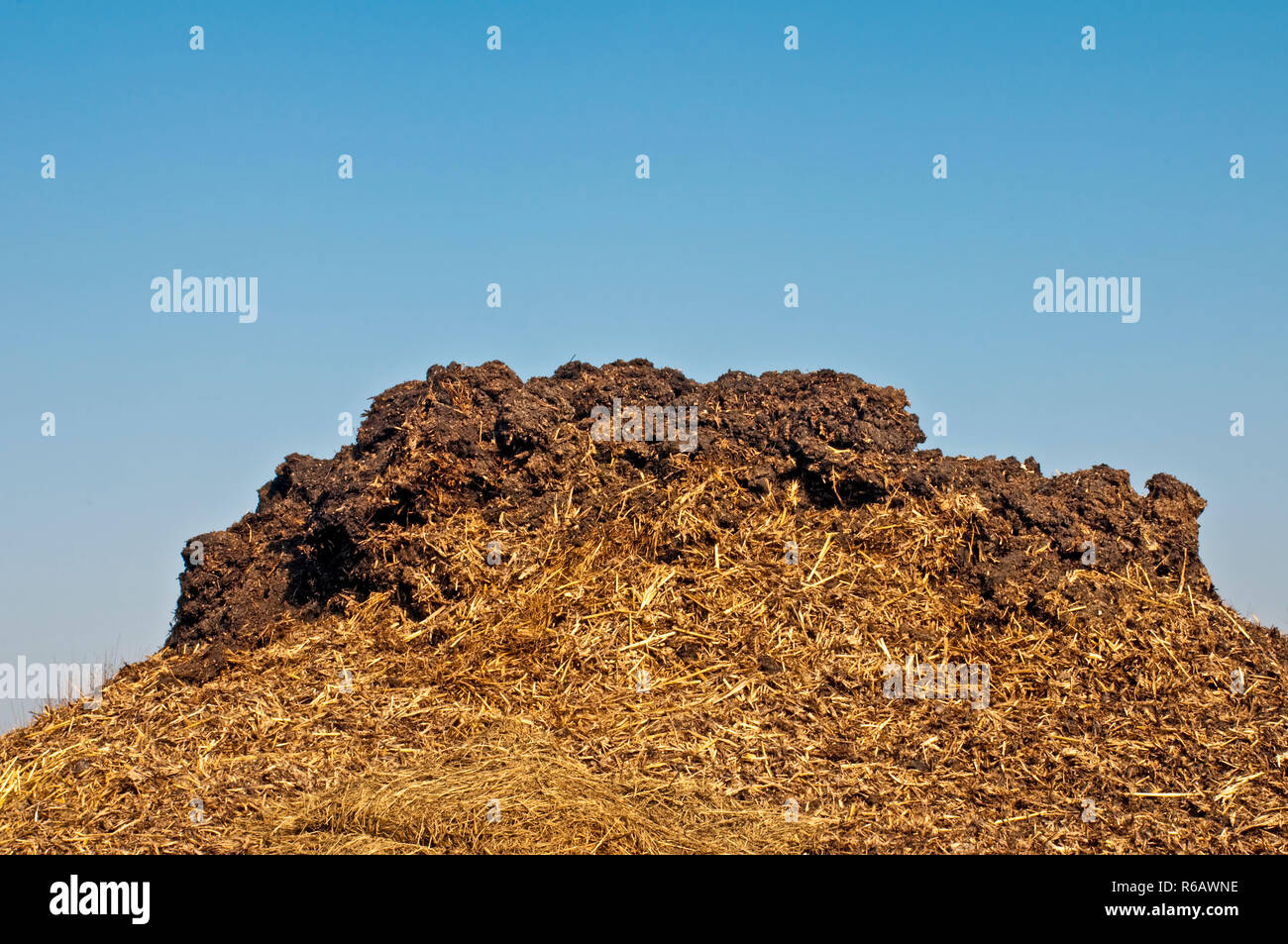 Dung Hill With A Blue Sky Stock Photo - Alamy