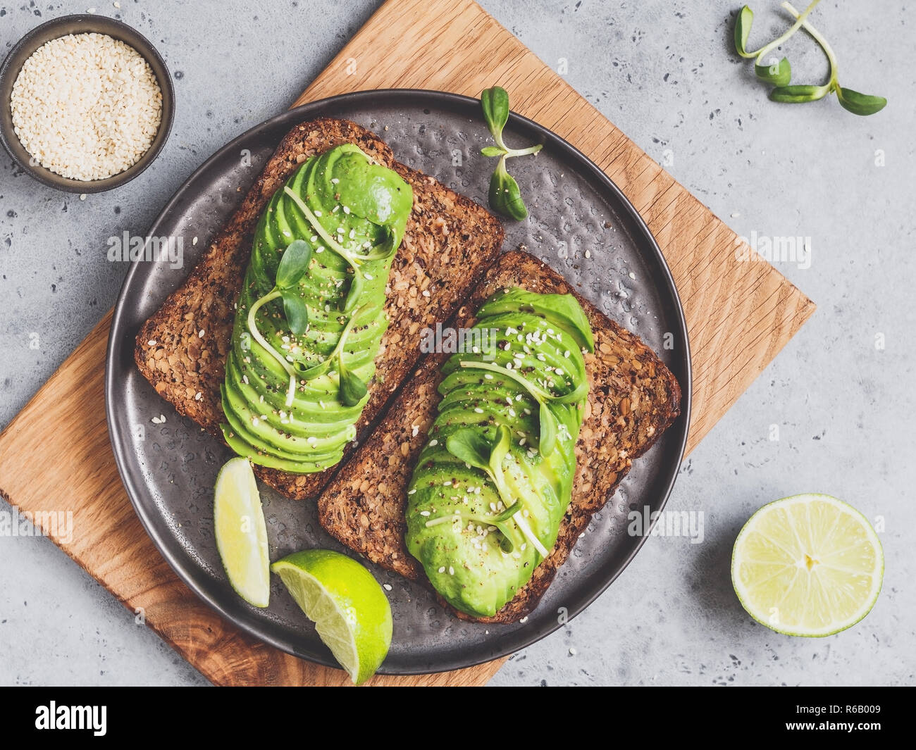 Top view on two toasts with avocado on a table. The concept of ...