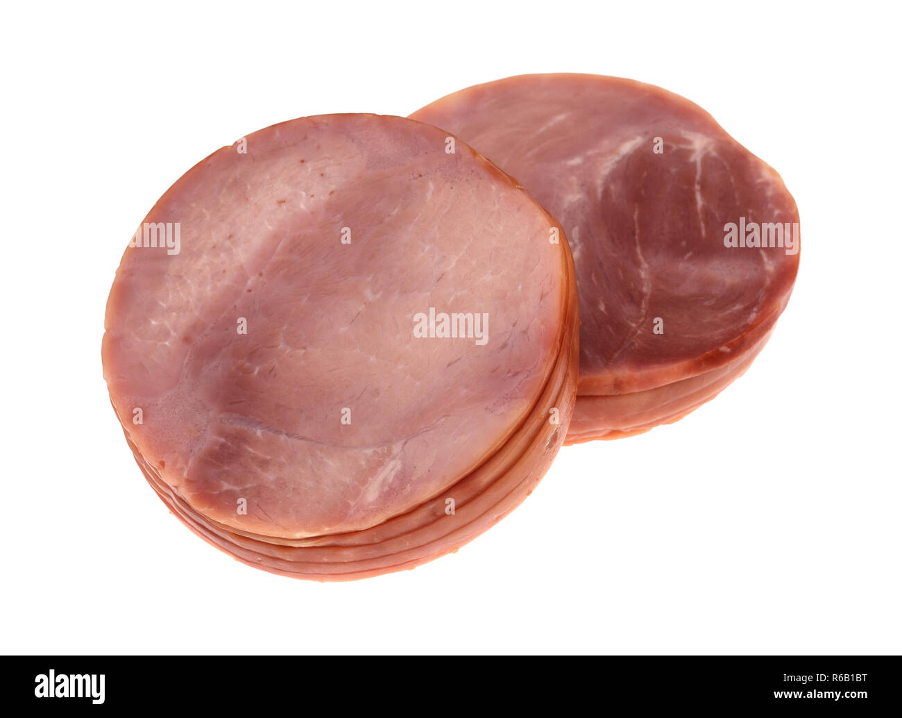 Side view of two stacks of round breakfast ham slices isolated on a ...