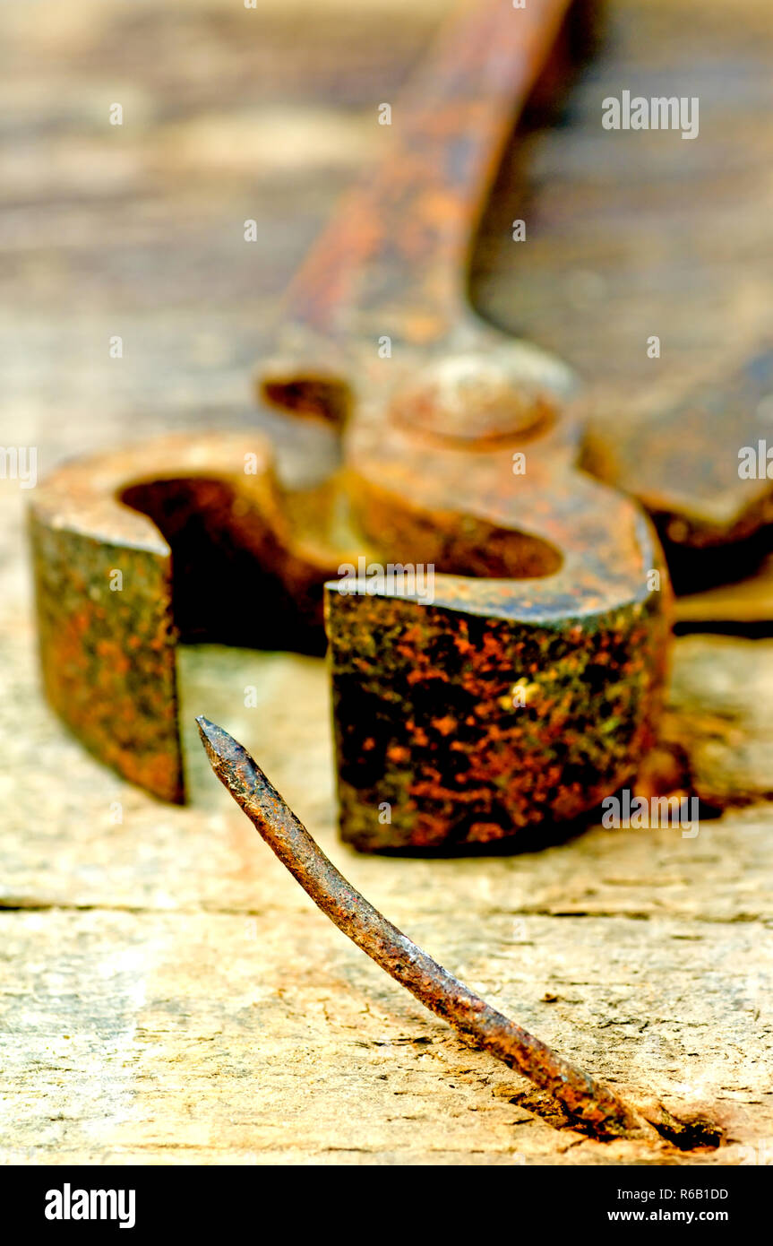 Old Rusty Pliers With Nail Stock Photo - Alamy