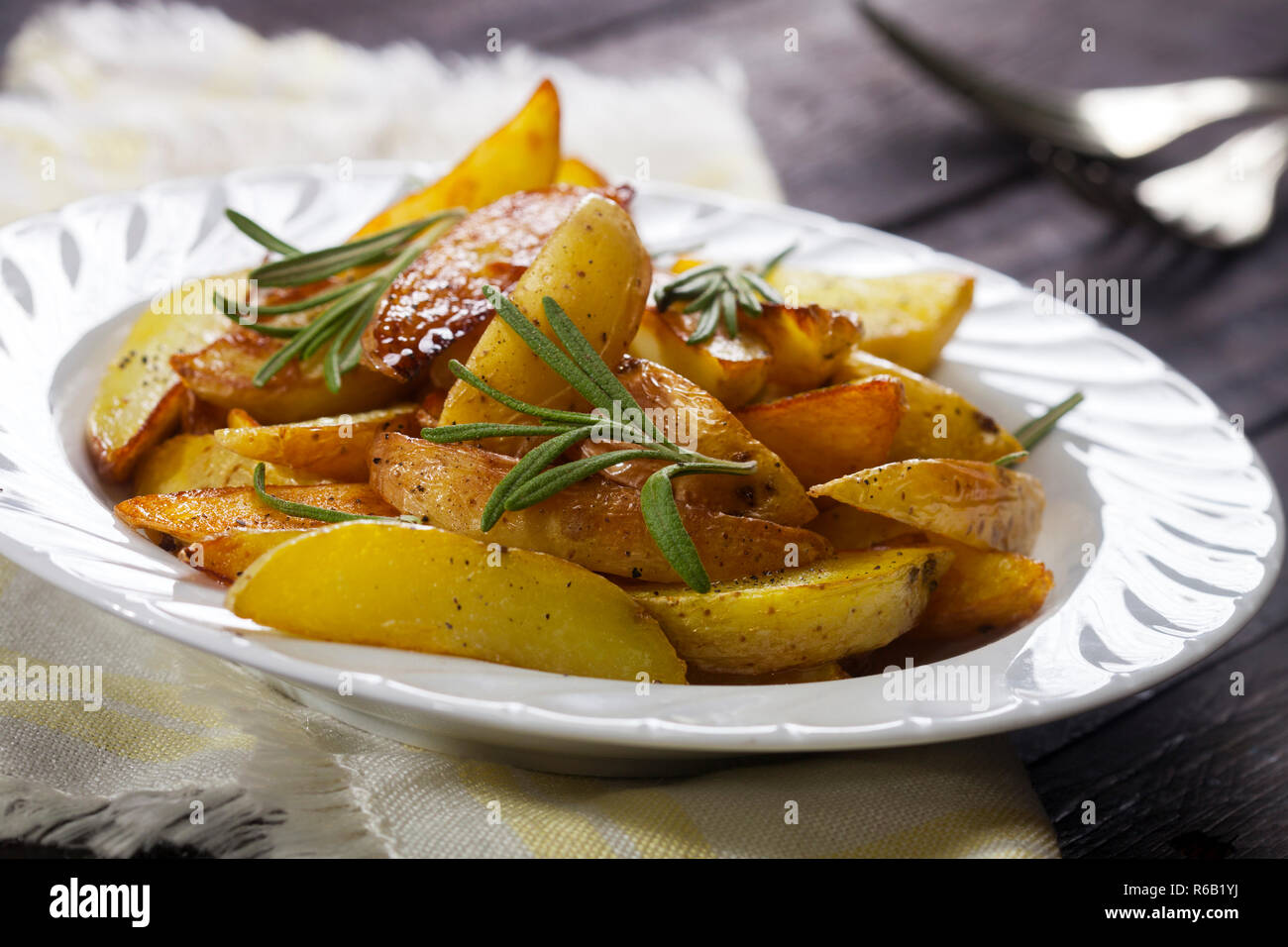 Baked potato wedges with rosemary. Homemade organic vegetable vegan ...
