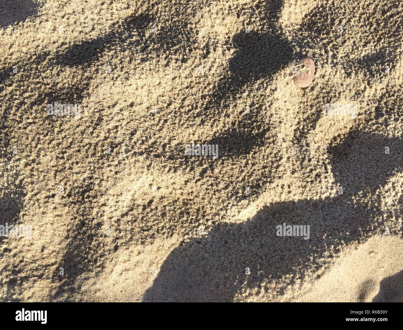 Sand Of A Beach With Waves Stock Photo - Alamy