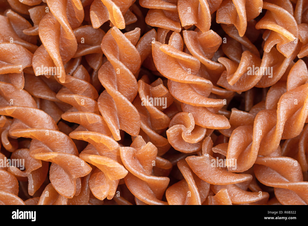 Very close view of spiral brown rice pasta Stock Photo - Alamy