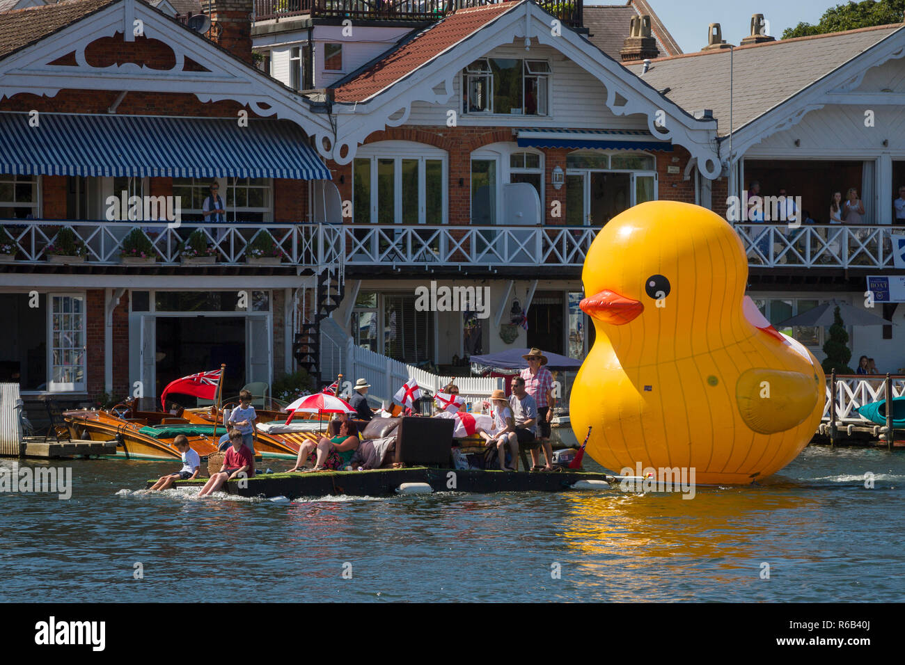 A giant inflatable plastic duck is towed along the river at Henley ...