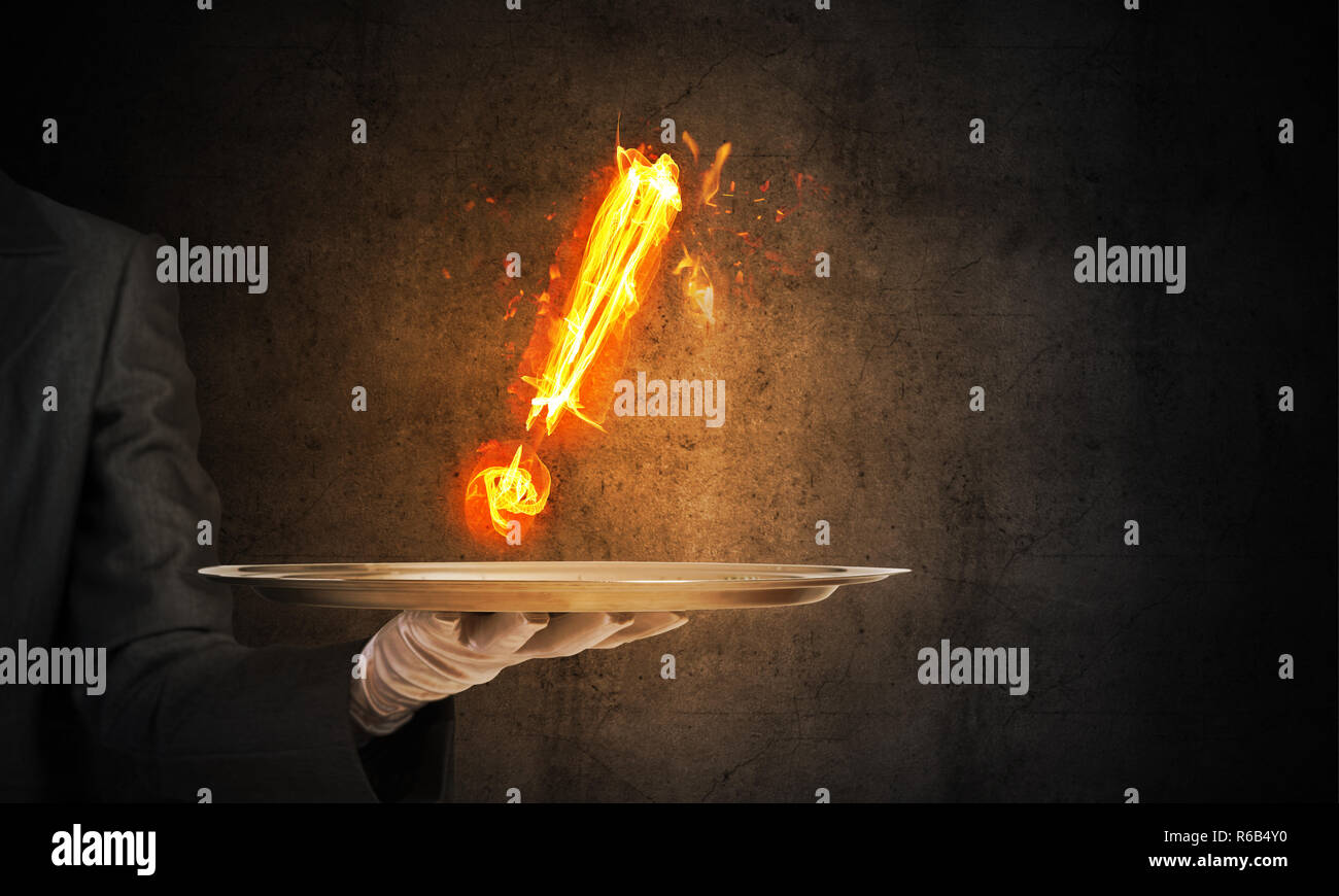 Waitress's hand keeping flaming exclamation mark Stock Photo - Alamy