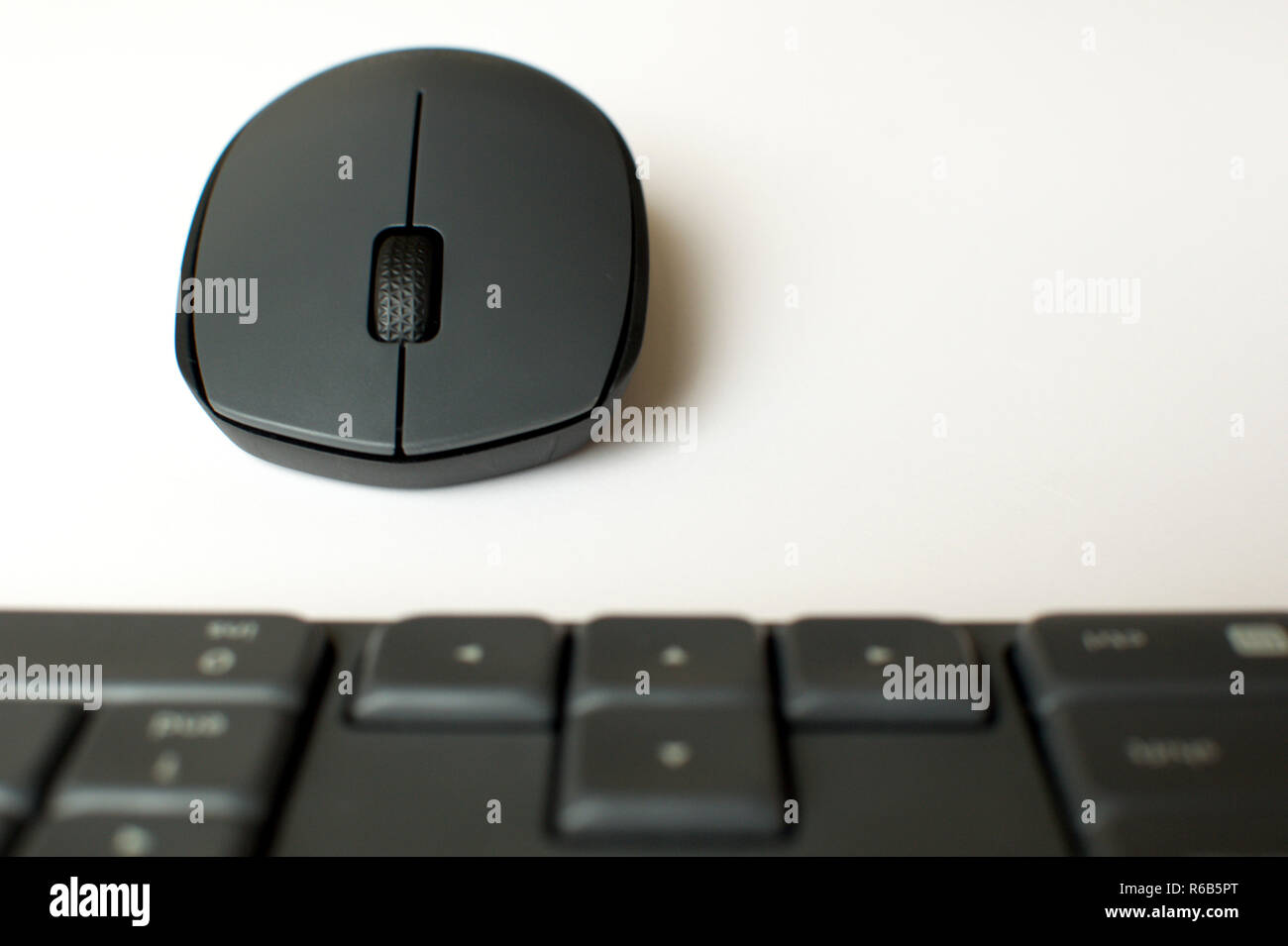 A gray wireless mouse and a keyboard Stock Photo - Alamy