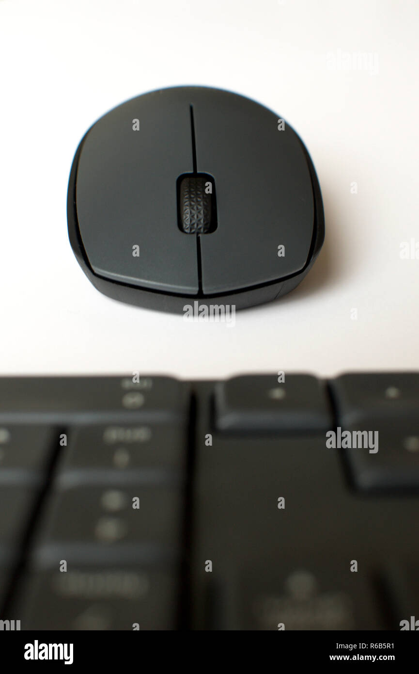 A gray wireless mouse and a keyboard Stock Photo - Alamy