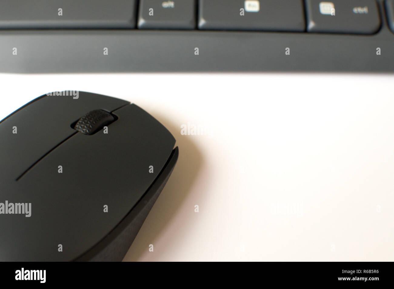 A gray wireless mouse and a keyboard Stock Photo - Alamy