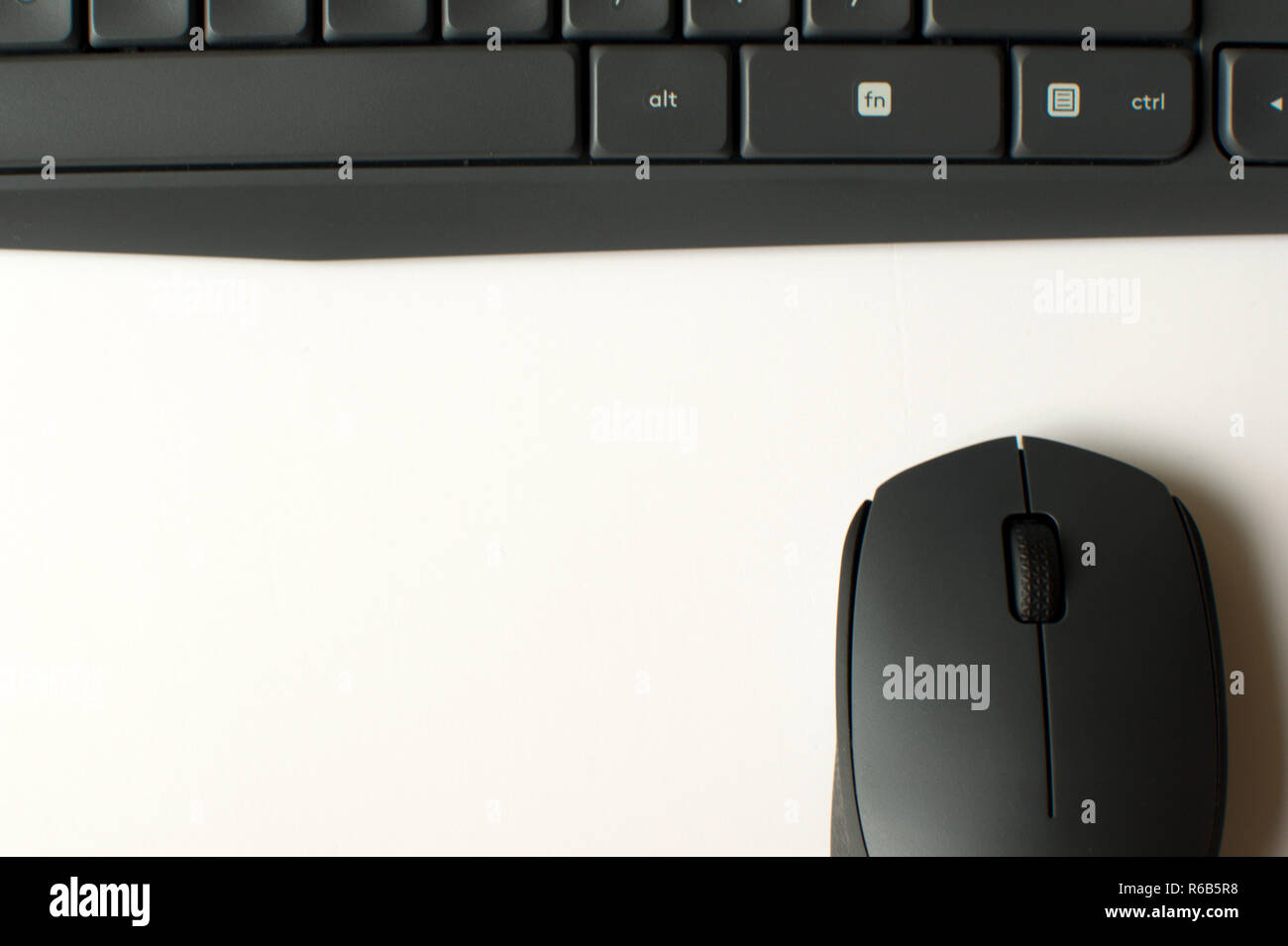A gray wireless mouse and a keyboard Stock Photo - Alamy