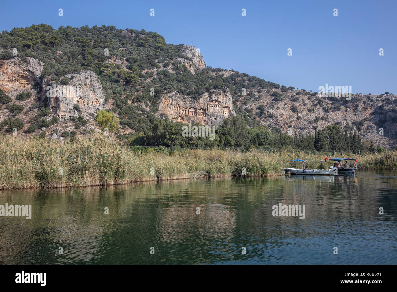 Boats view at slope of Lycians rock tombs in Dalyan Town Stock Photo ...