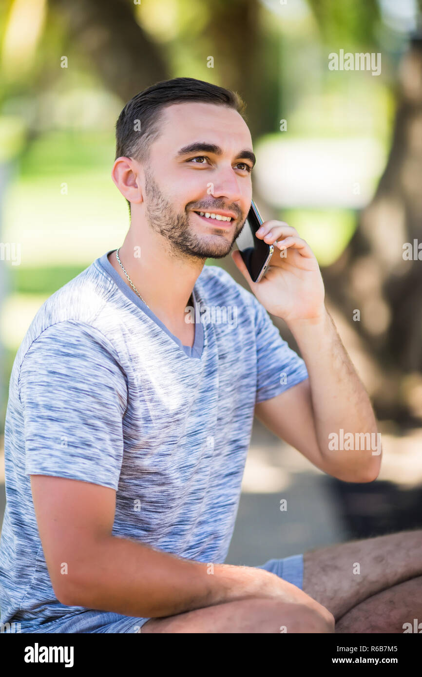 handsome young man talking on the cell phone Stock Photo - Alamy