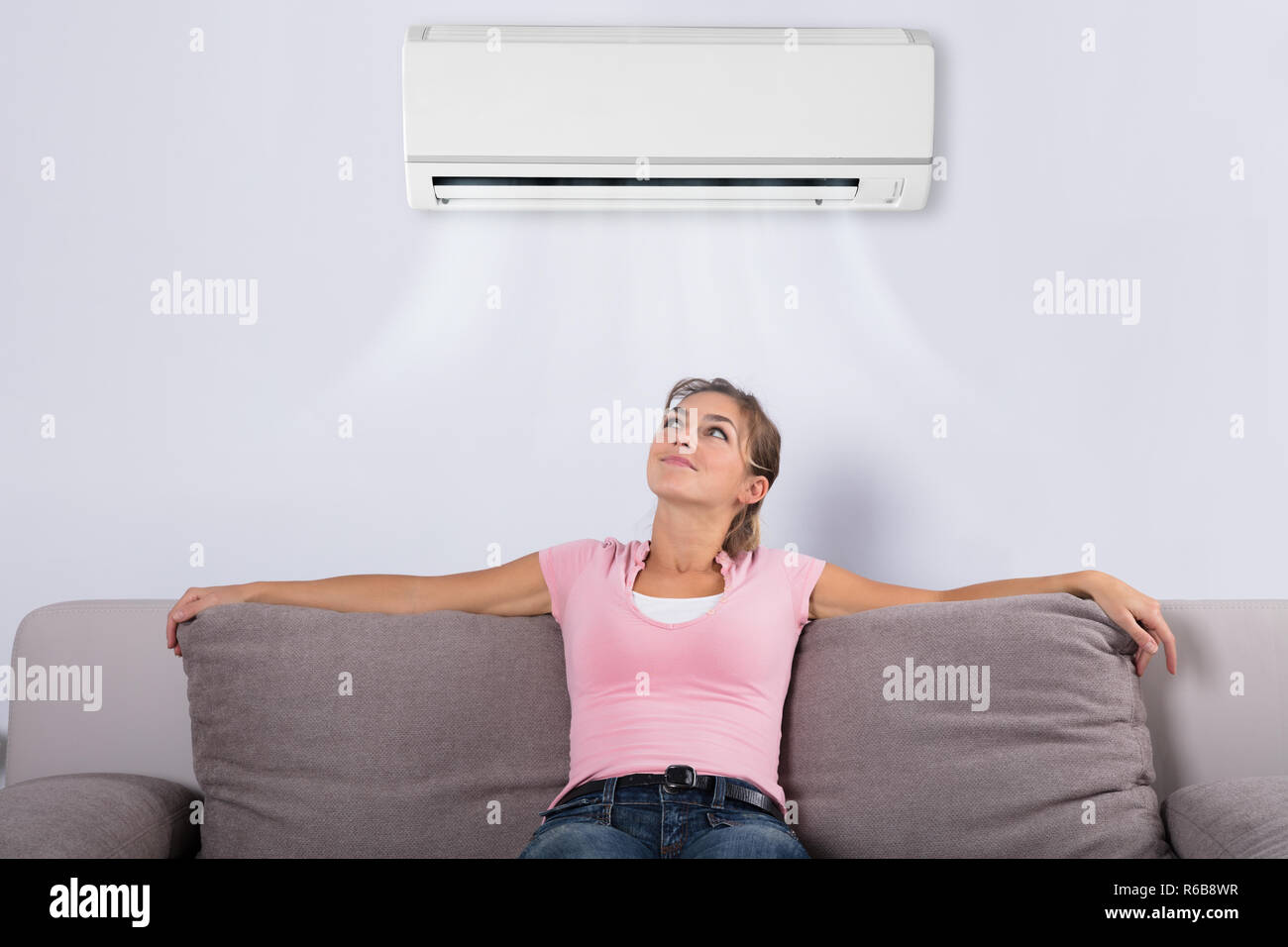 Woman Relaxing Under The Air Conditioner Stock Photo - Alamy