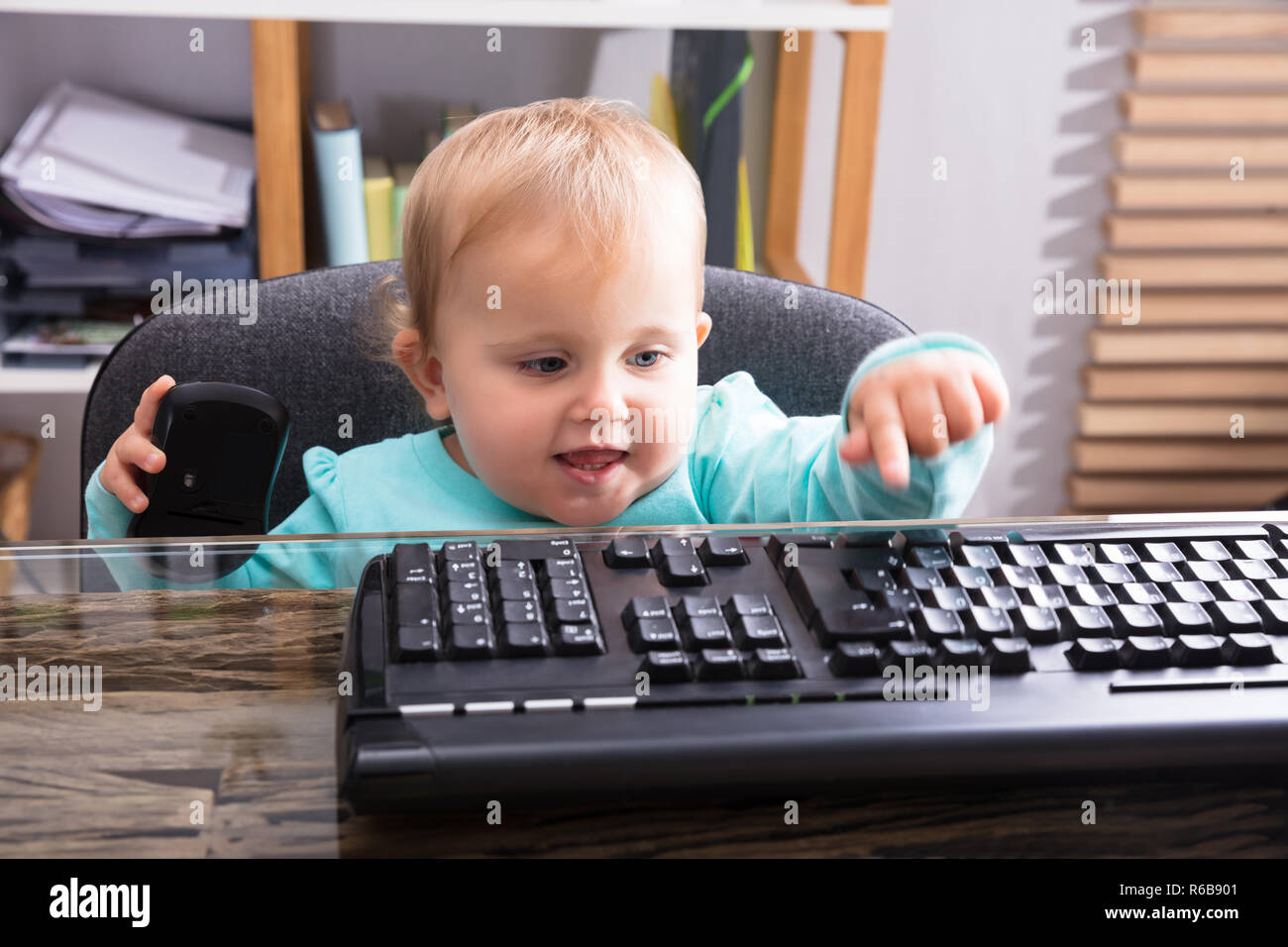 Baby Girl Typing On Keyboard Stock Photo - Alamy