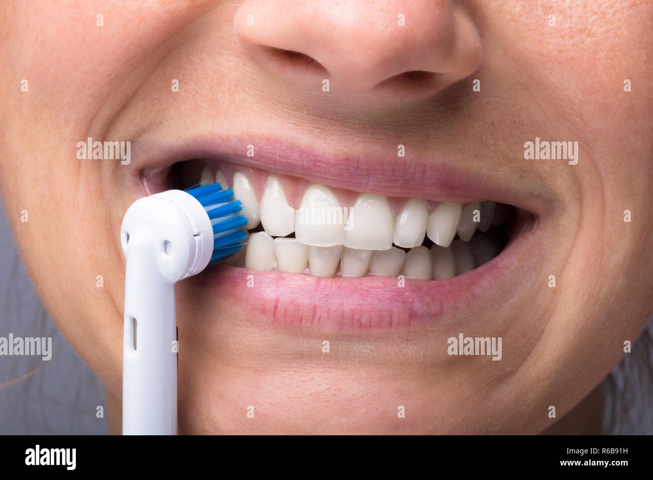 Woman's Teeth With Electrical Toothbrush Stock Photo - Alamy