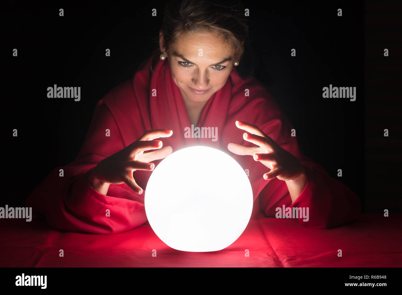 Hands around a crystal ball hi-res stock photography and images - Alamy