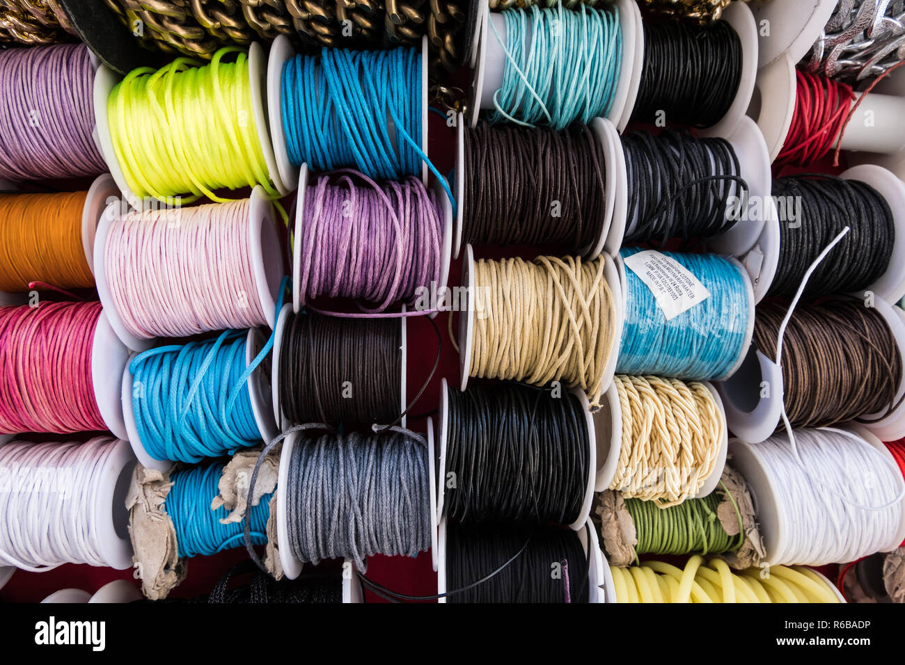 Wallpaper background texture of colorful spools of thread reels for ...