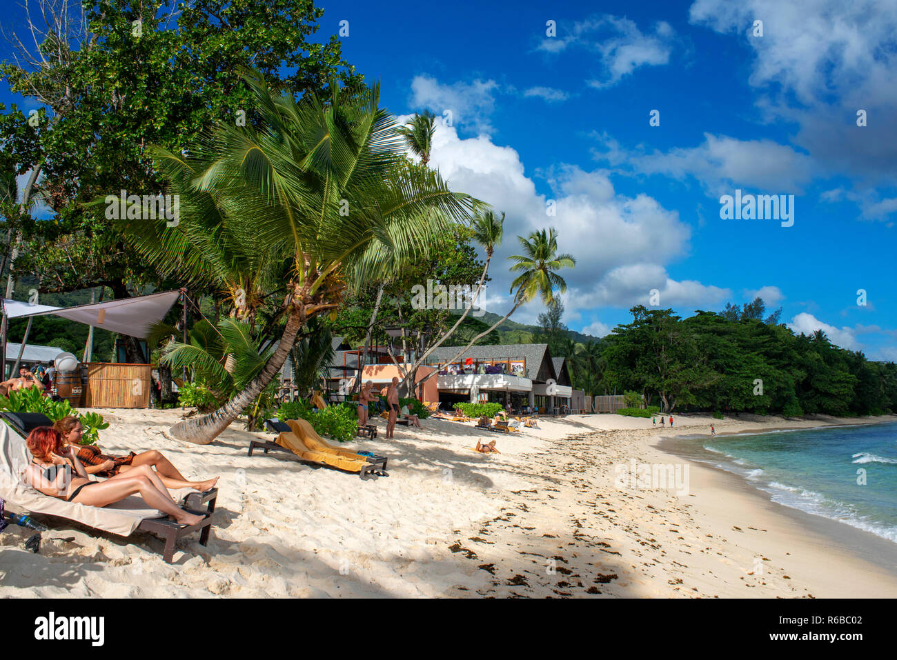 Tourists on the beach in The Baia at Avani Barbarons Mahe Seychelles ...