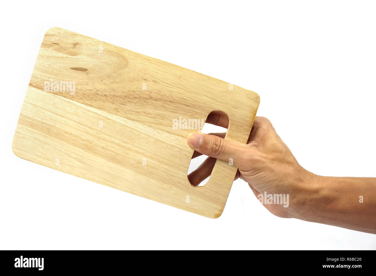 A Cropped of man hand holding wooden plate against white background ...