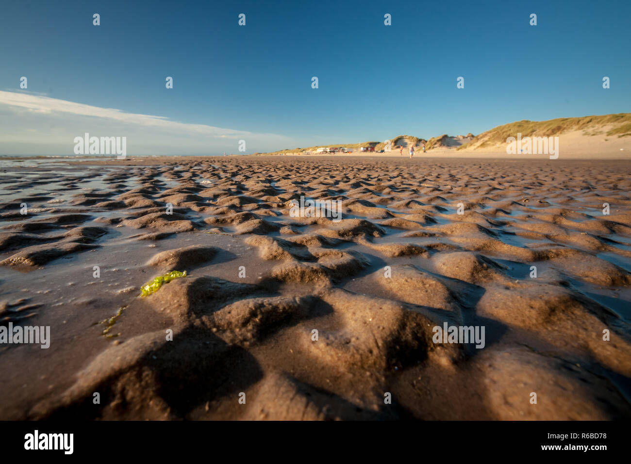 Sea water flowing over sand leaving abstract patterns, natural ...