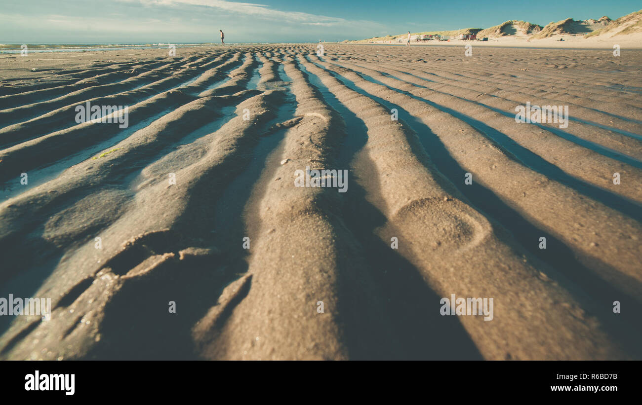 Sea water flowing over sand leaving abstract patterns, natural ...