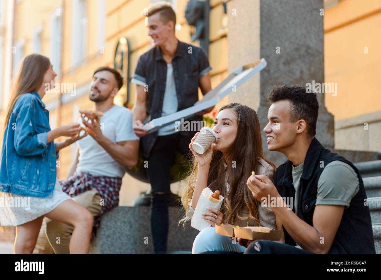 Young people eating junk food Stock Photo - Alamy