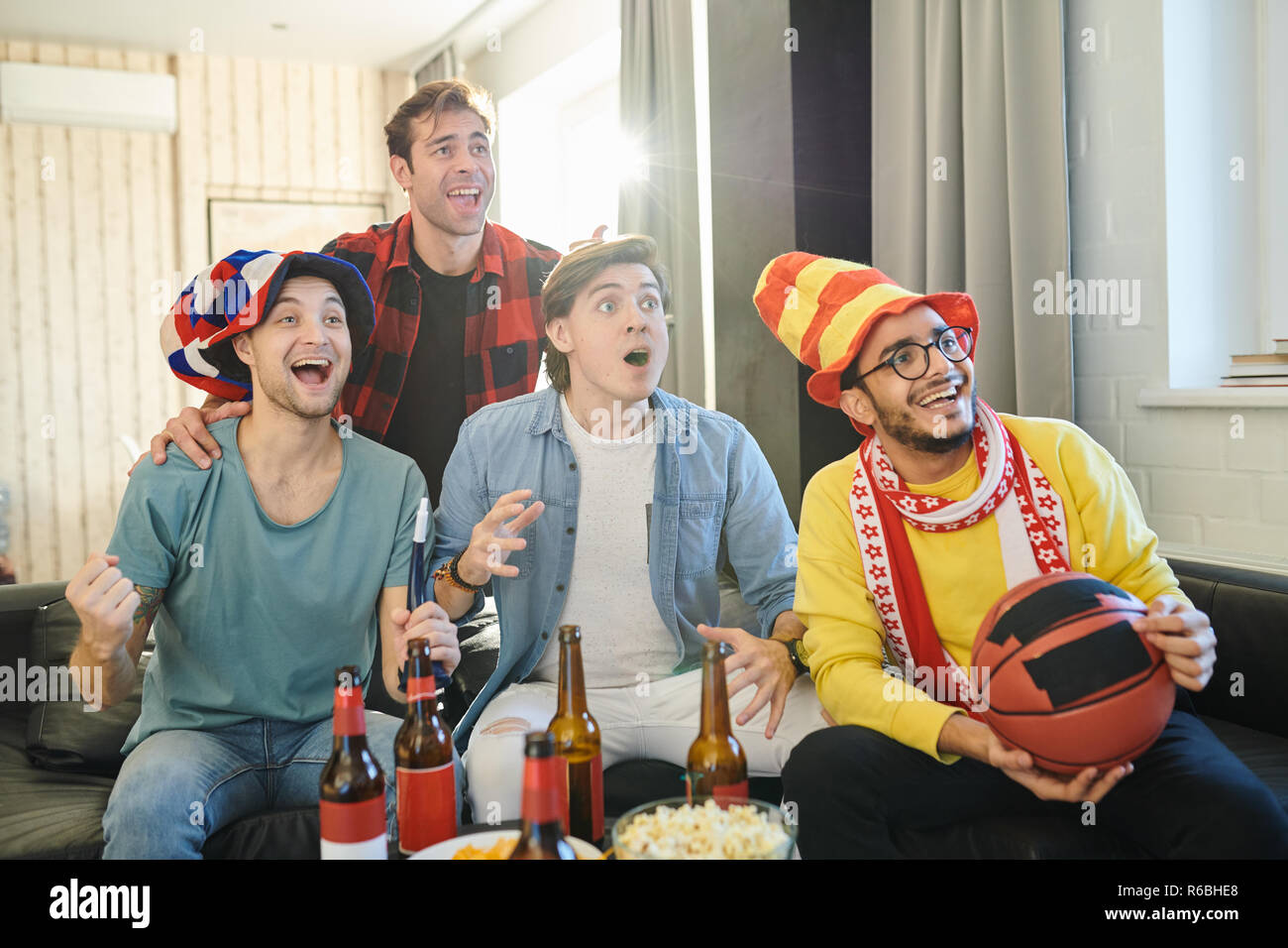 Basketball fans having fun at home Stock Photo - Alamy