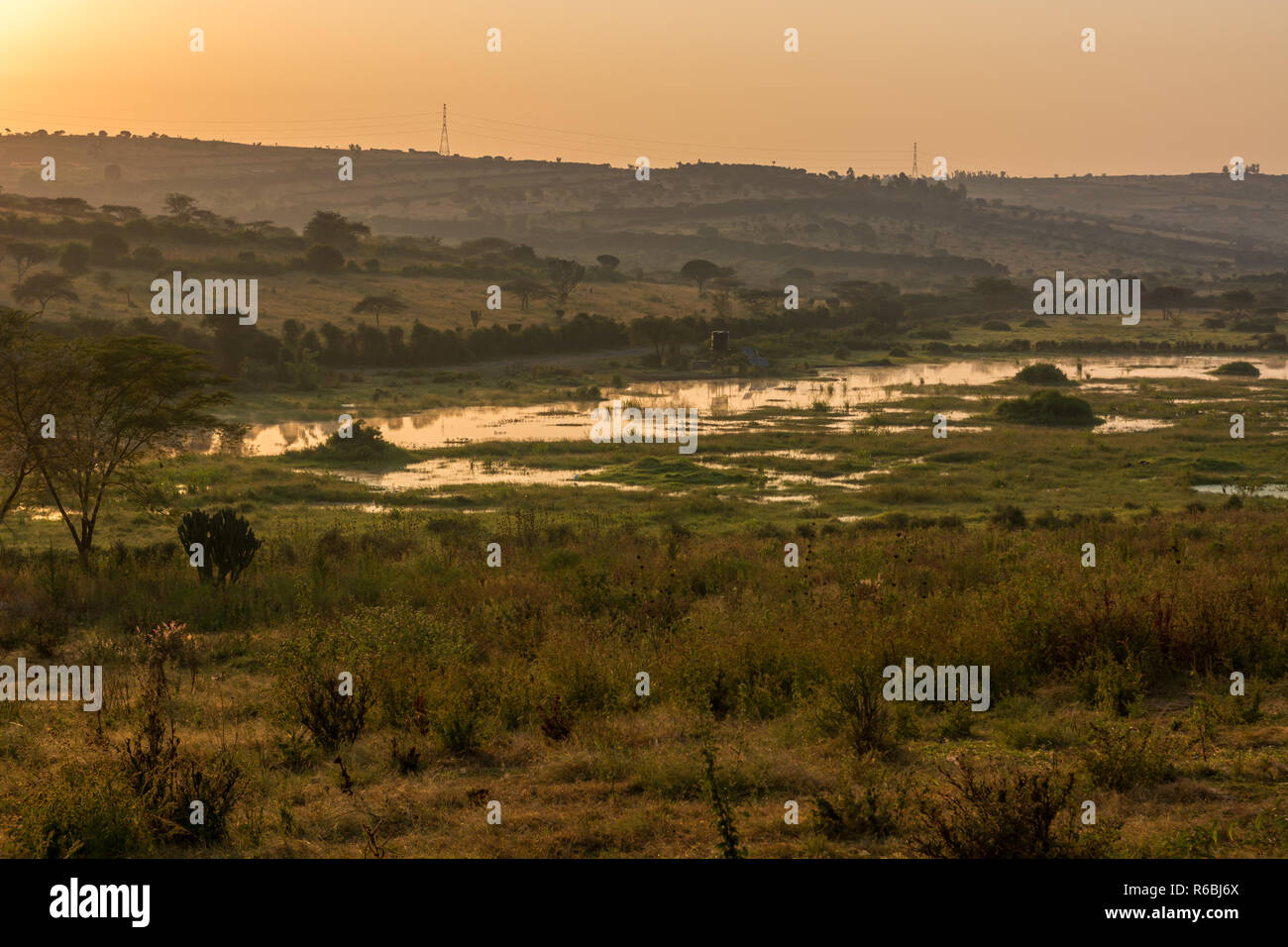 Spectacular savannah landscape of sun raising above marshes. Rwanda ...