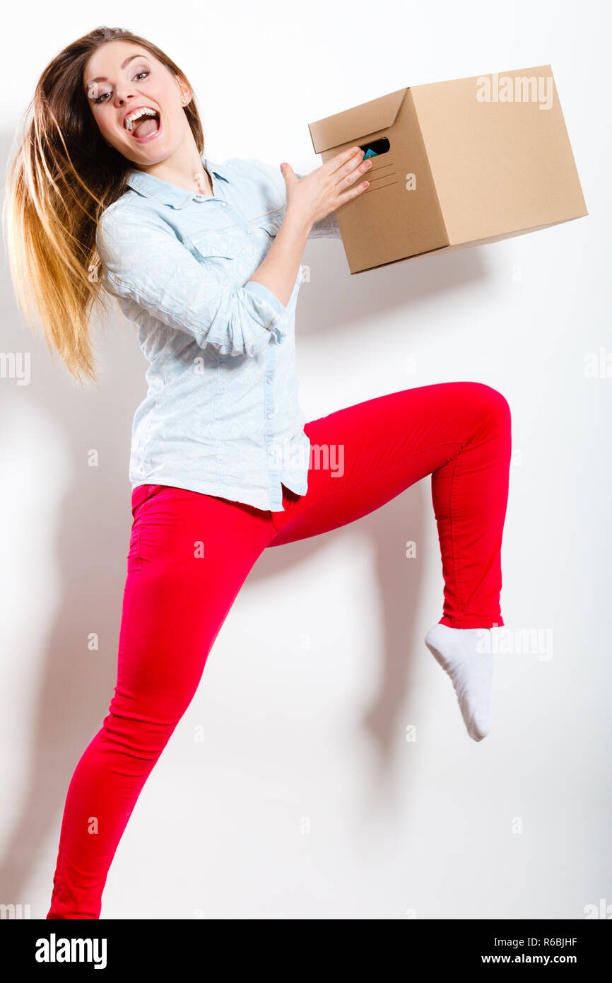 Happy woman moving in carrying carton box. Young girl arranging ...