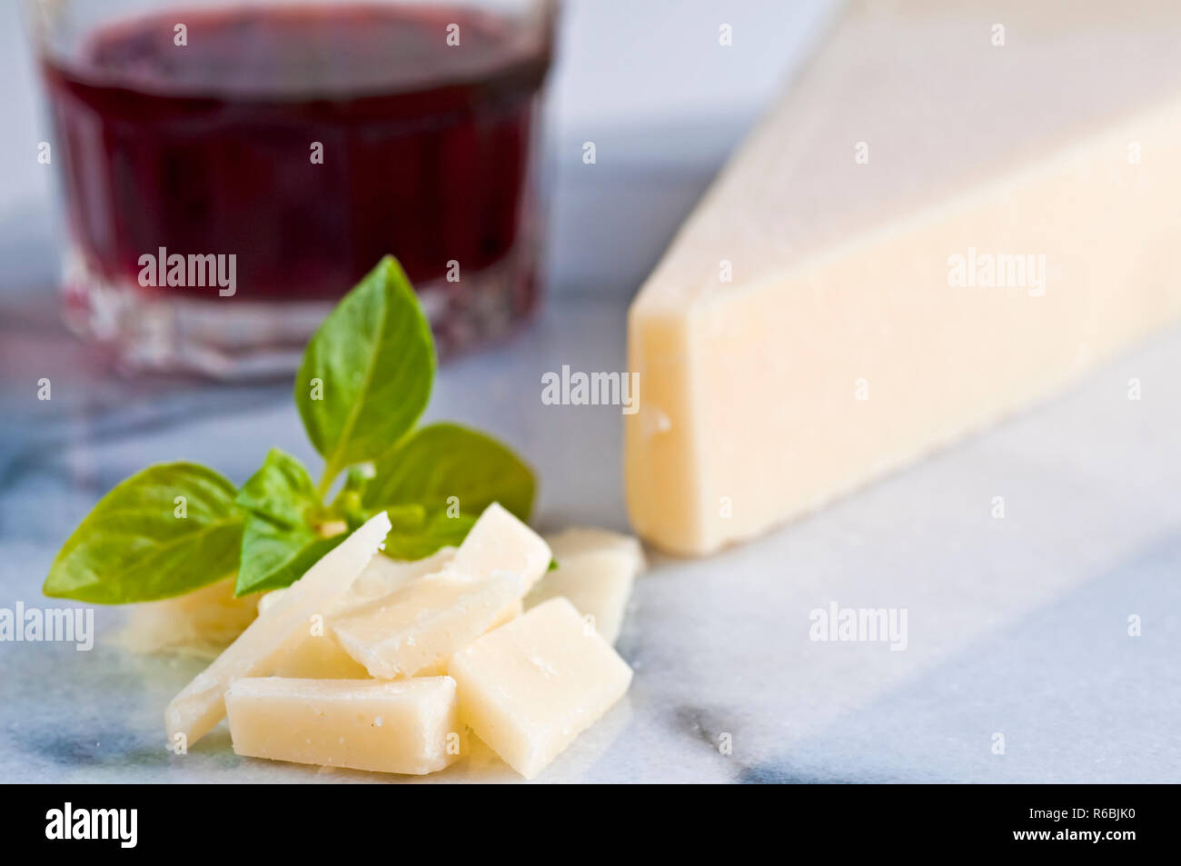 Parmesan Cheese With Basil And Red Wine Stock Photo - Alamy