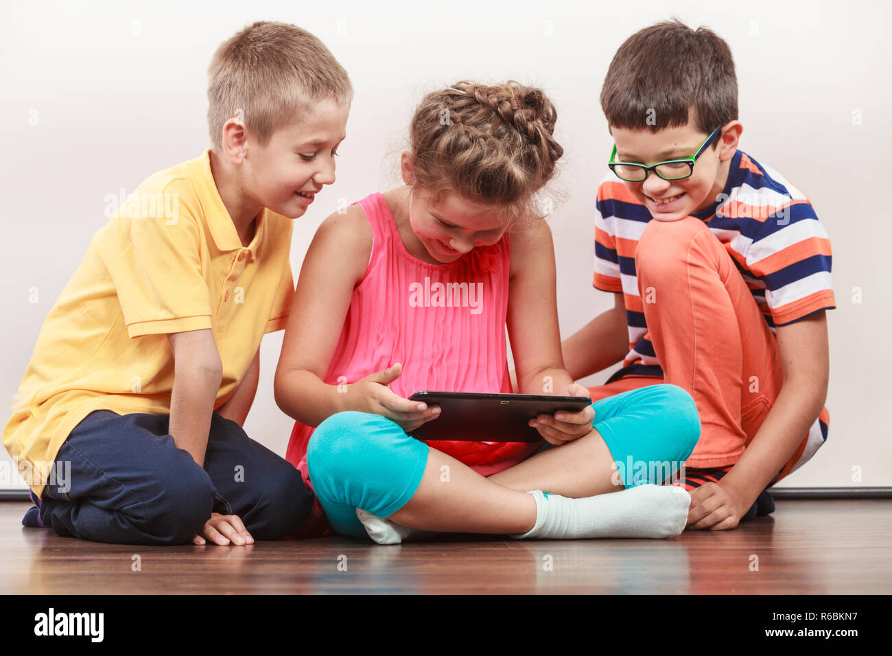 Kids playing on tablet. Having fun and learning Stock Photo - Alamy