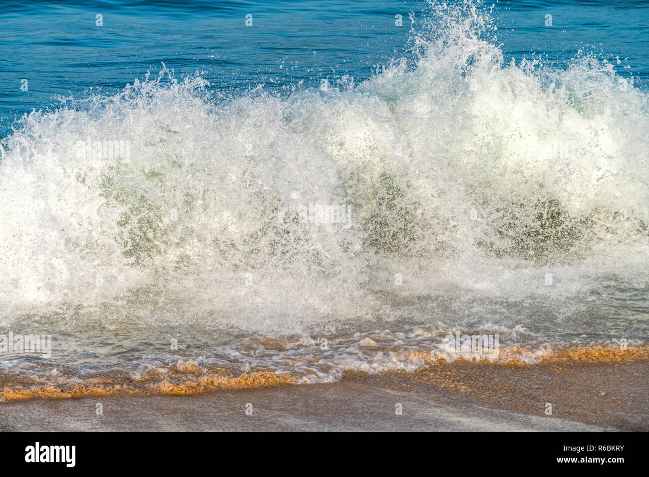 Breaking waves on a beach Stock Photo - Alamy