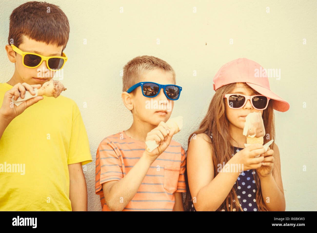 Kids eating gelato and soft serve ice cream. Boys and little girl in ...