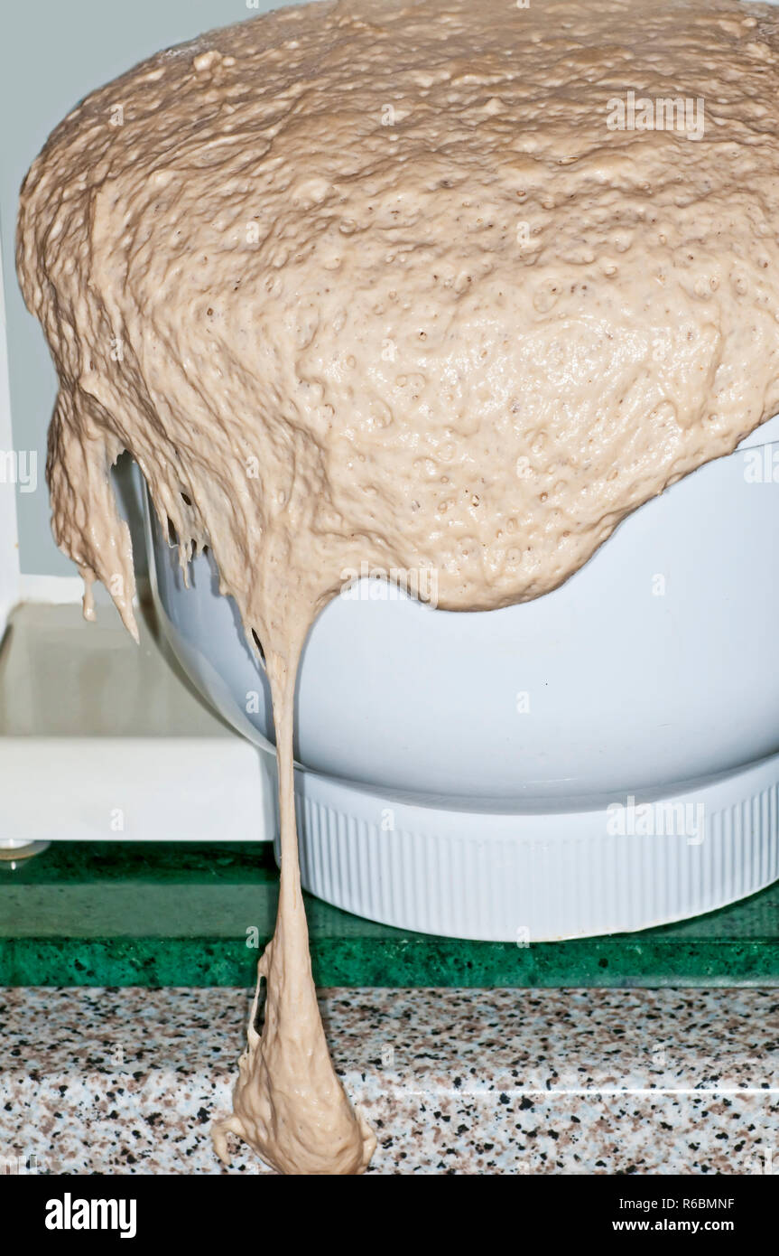 Yeast Dough Running Over Stock Photo - Alamy