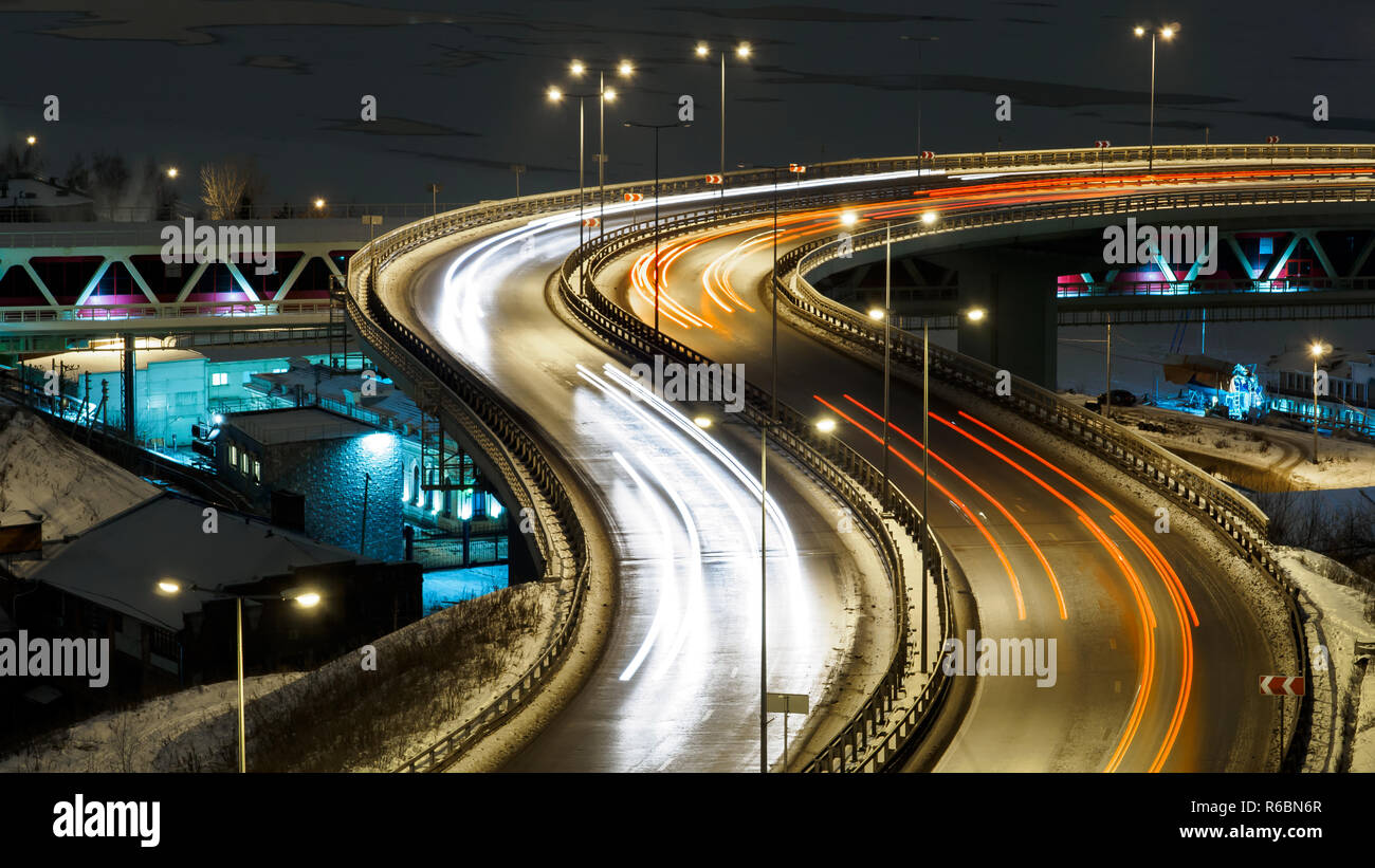 View on night city traffic on the bridge through wide river, with sharp ...