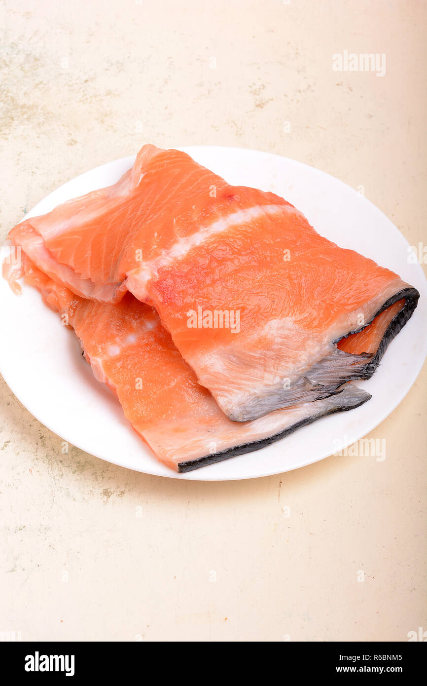 fresh salmon fillet close up on white plate Stock Photo - Alamy