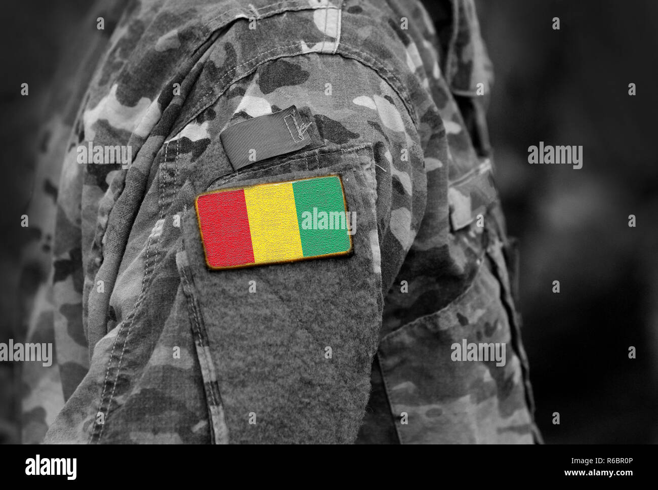 Republic of Guinea flag on soldiers arm. Guinea flag on military ...