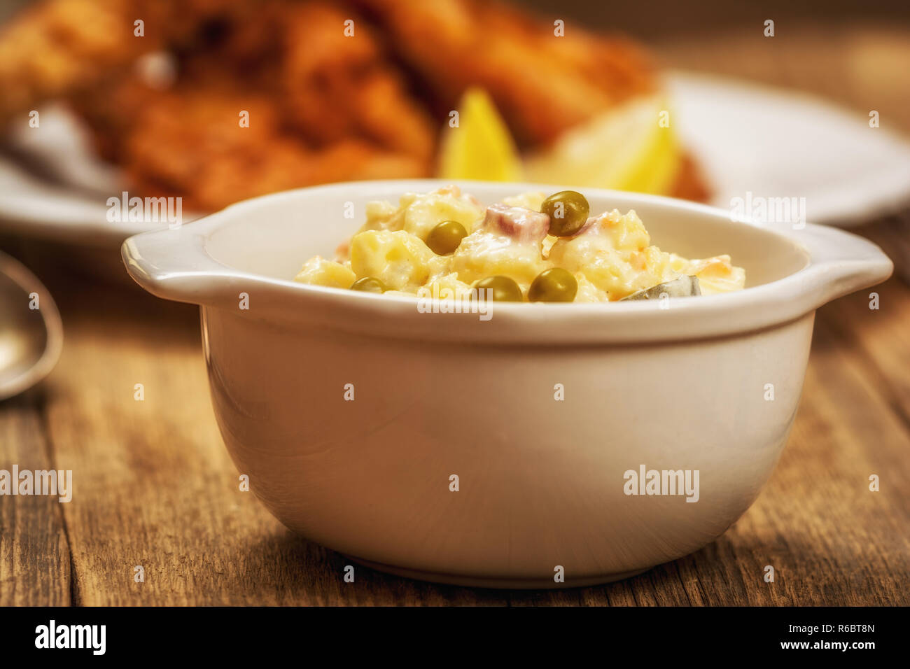 Traditional czech potato salad with mayonnaise and vegetables in white ...