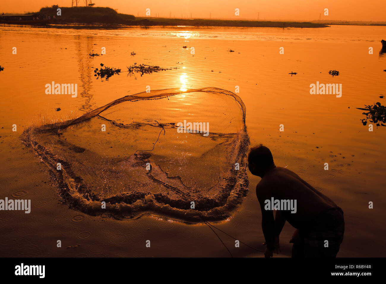 A man catch fish during the sun setting in Dhaka, Bangladesh Stock ...