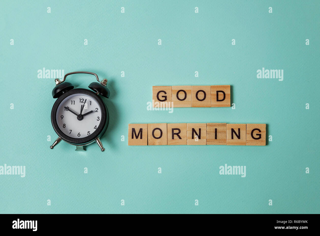 Simply flat lay design alarm clock and Inscription GOOD MORNING letters ...