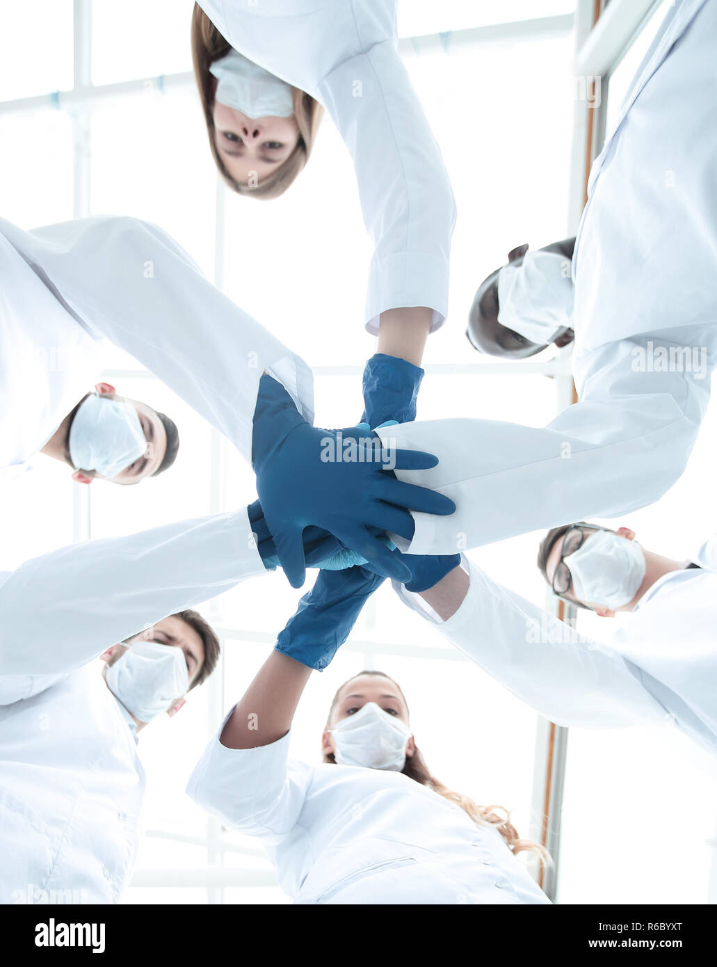 Doctors and nurses in a medical team stacking hands Stock Photo - Alamy