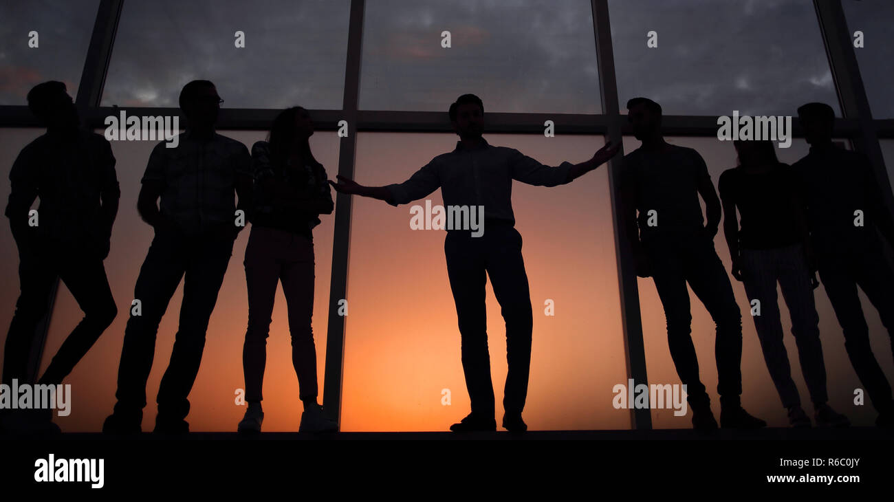 leader and the business team on background of office window Stock Photo ...