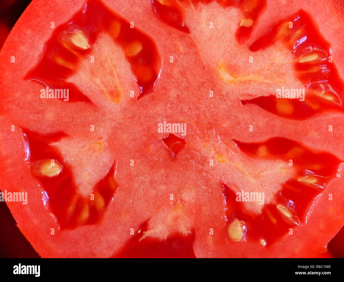 Slicing Tomato Cut In Half, Macro Stock Photo - Alamy